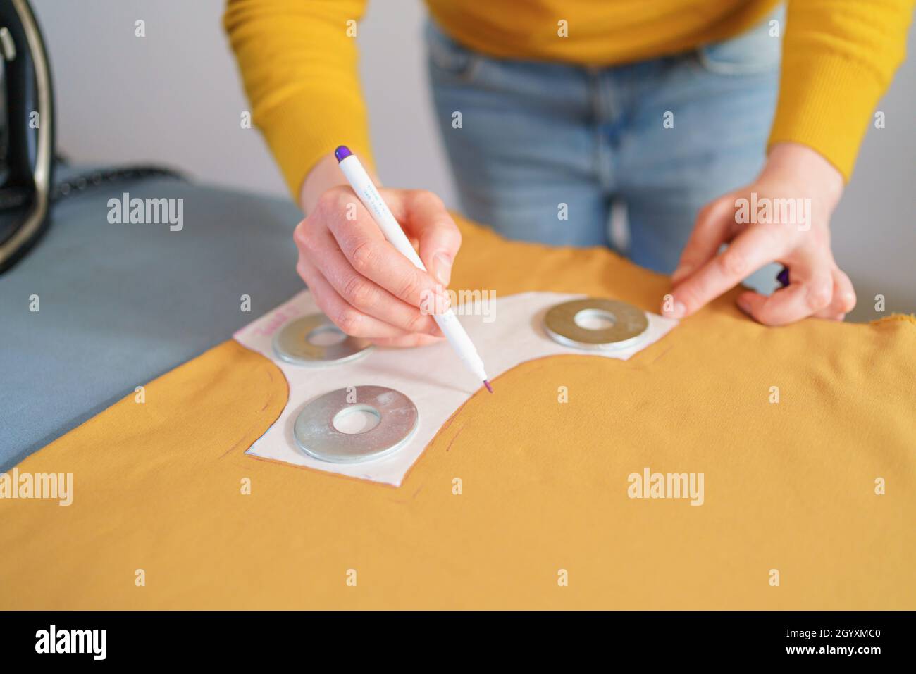 Female seamstress making sewing pattern while working at her creative ...