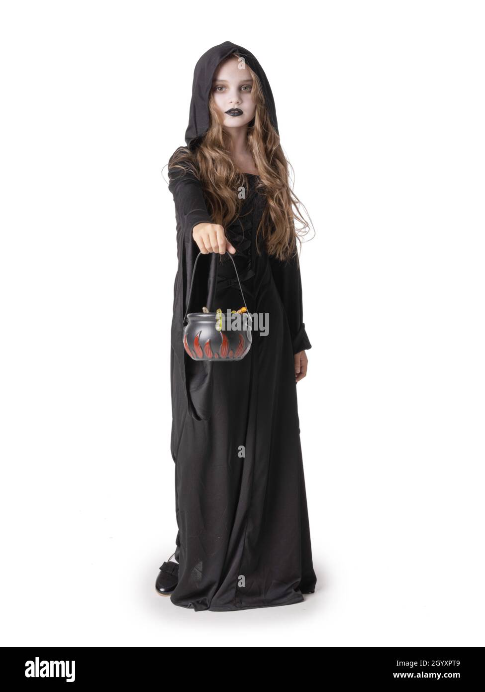 Portrait of little girl in black cloak clothing with cauldron basket of ...