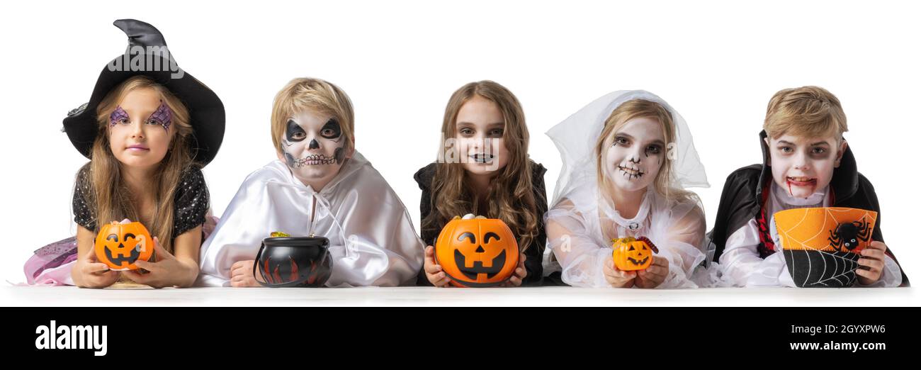 Group of children in fancy Halloween costumes with bucket with candies ...