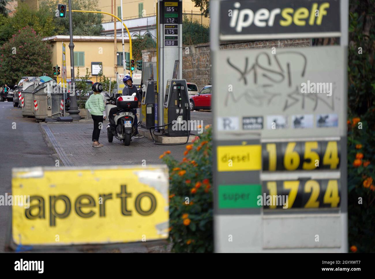 Rome, Italy. 9th Oct, 2021. Customers fuel a motorcycle at a gas ...