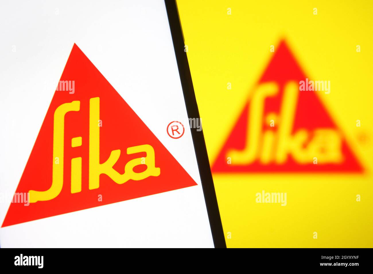 In this photo illustration a Sika AG logo is seen on a smartphone and a ...