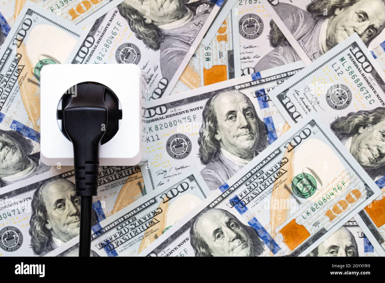 plug and socket on 100 dollar backgroubd Stock Photo - Alamy