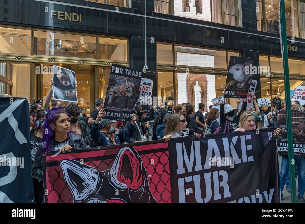 Animal rights activists protest with placards and banners during an ...