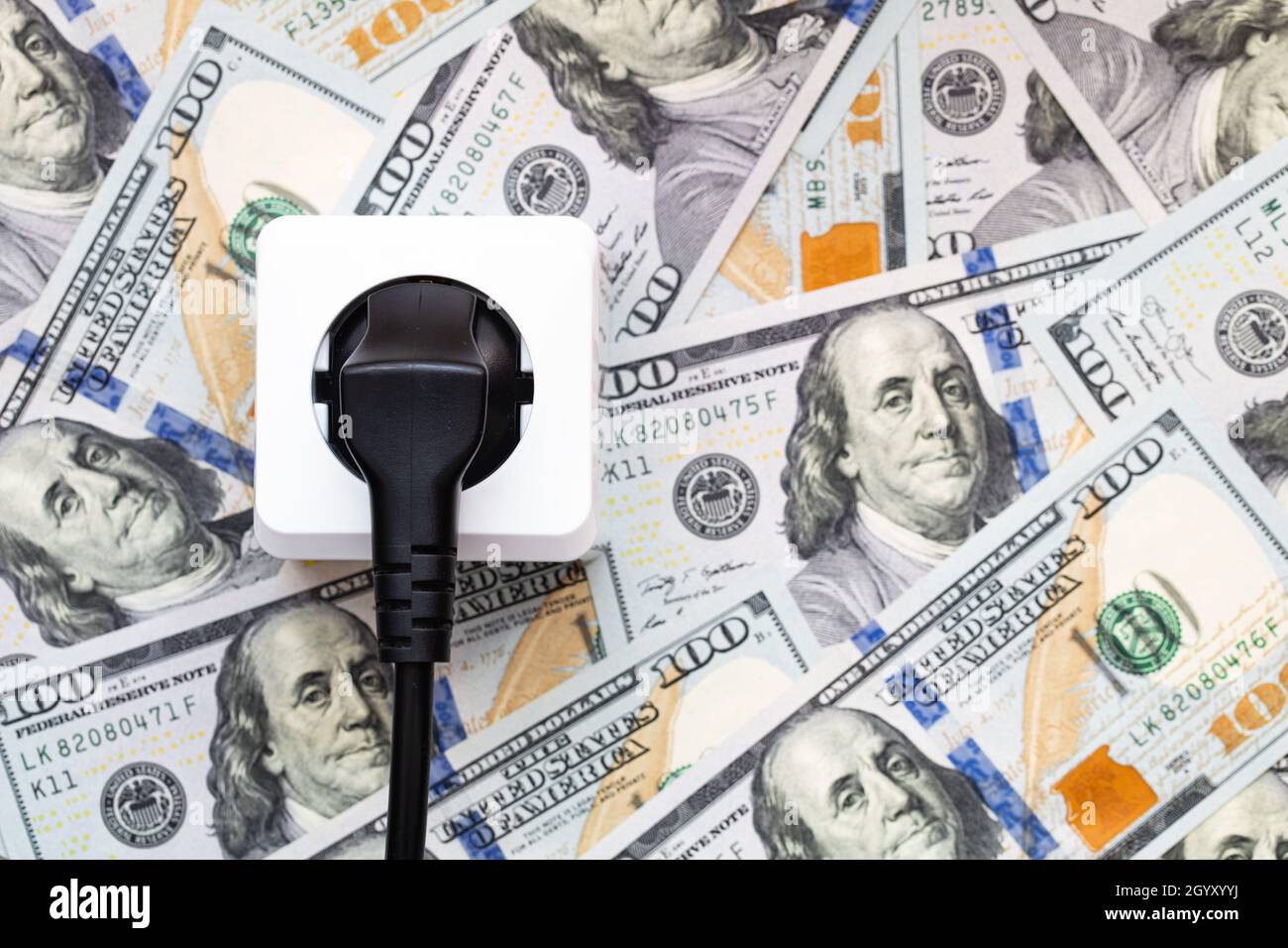 plug and socket on 100 dollar backgroubd Stock Photo - Alamy