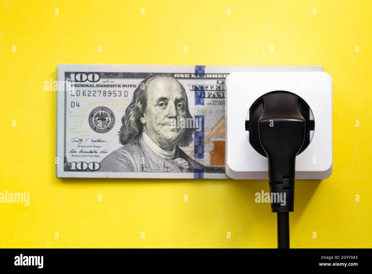 plug and socket on 100 dollar backgroubd Stock Photo - Alamy