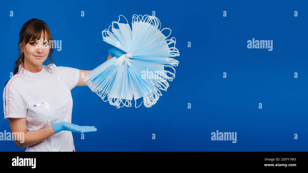 the doctor is holding a bunch of medical masks stacked together on a ...