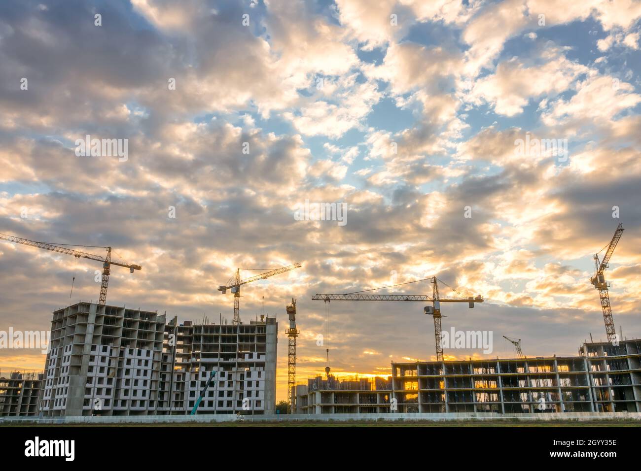 Summer sunset at the construction of residential buildings. Lots of ...