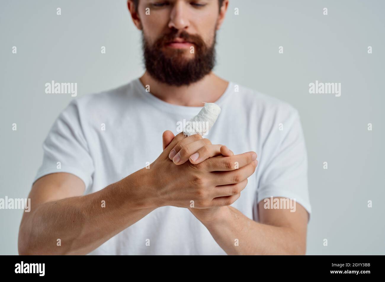 sick man bandaged hand injury to fingers light background Stock Photo ...