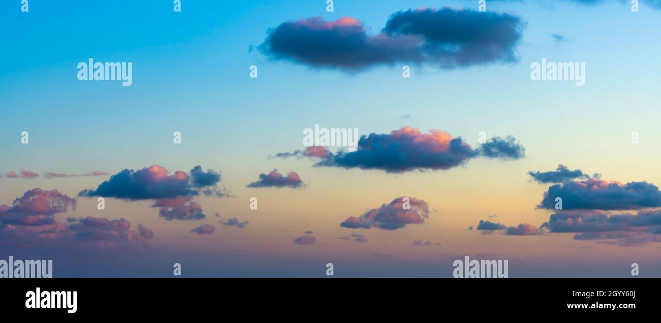 Natural background, stunning view of some fluffy clouds on a purple and ...