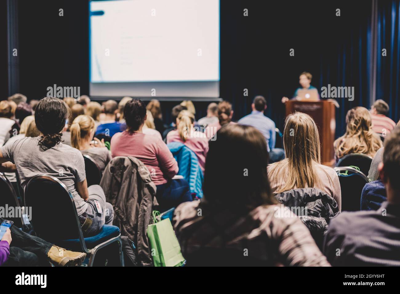 Audience in lecture hall participating at business event Stock Photo ...