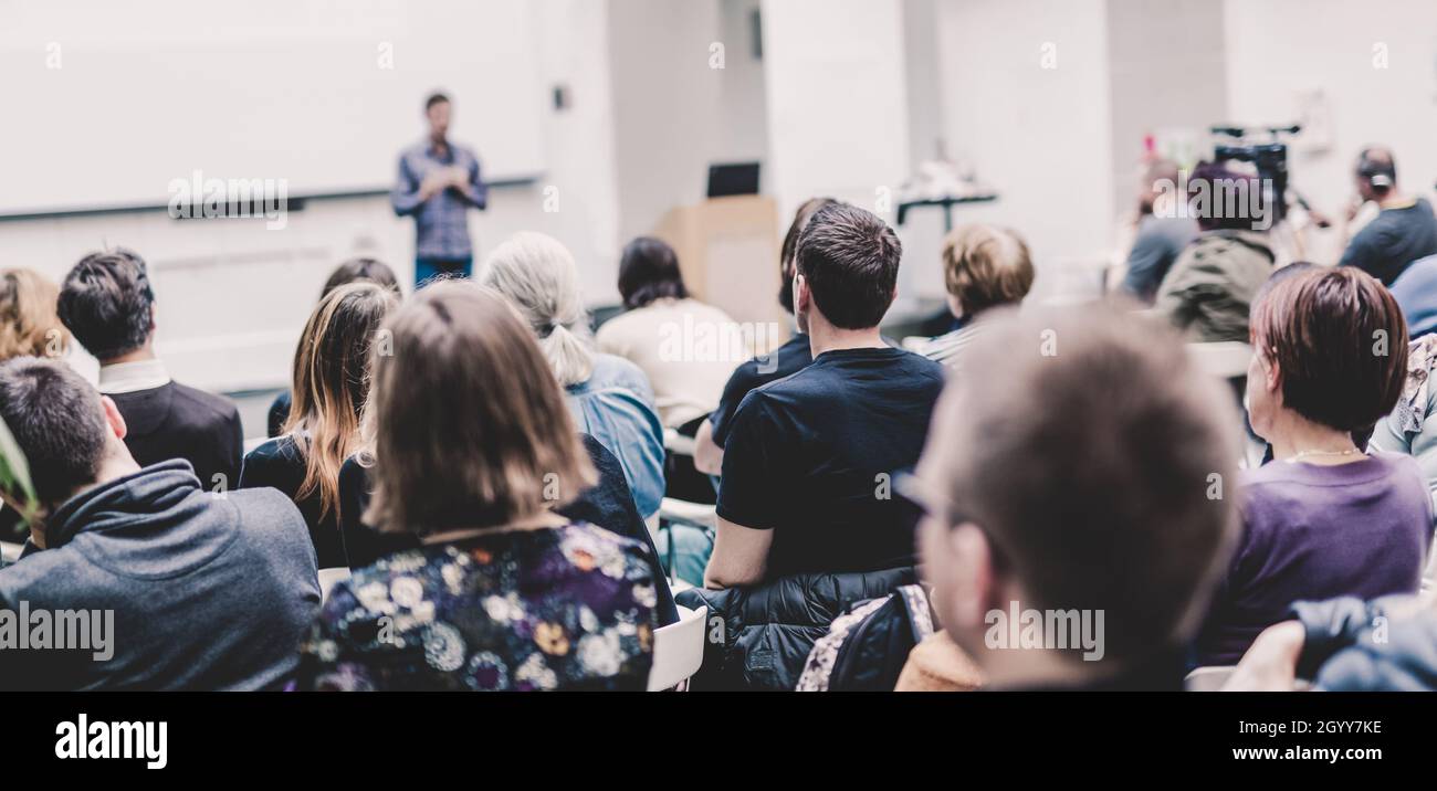 Man giving presentation in lecture hall at university Stock Photo - Alamy