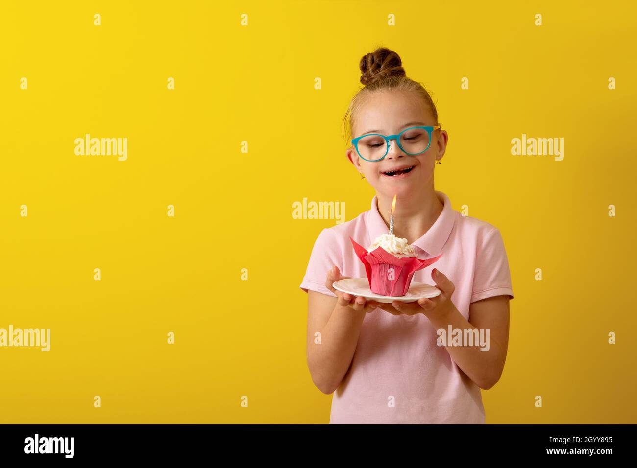 Happy girl with Down syndrome. Having fun, laughing. Funny pigtails ...