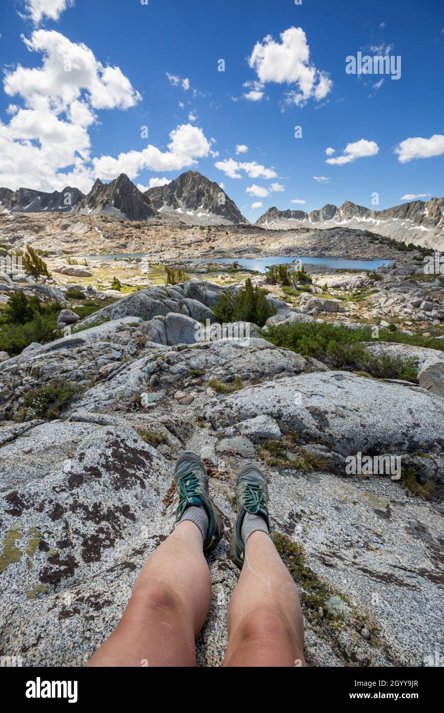 feet of a resting hiker against a mountain backdrop Stock Photo - Alamy