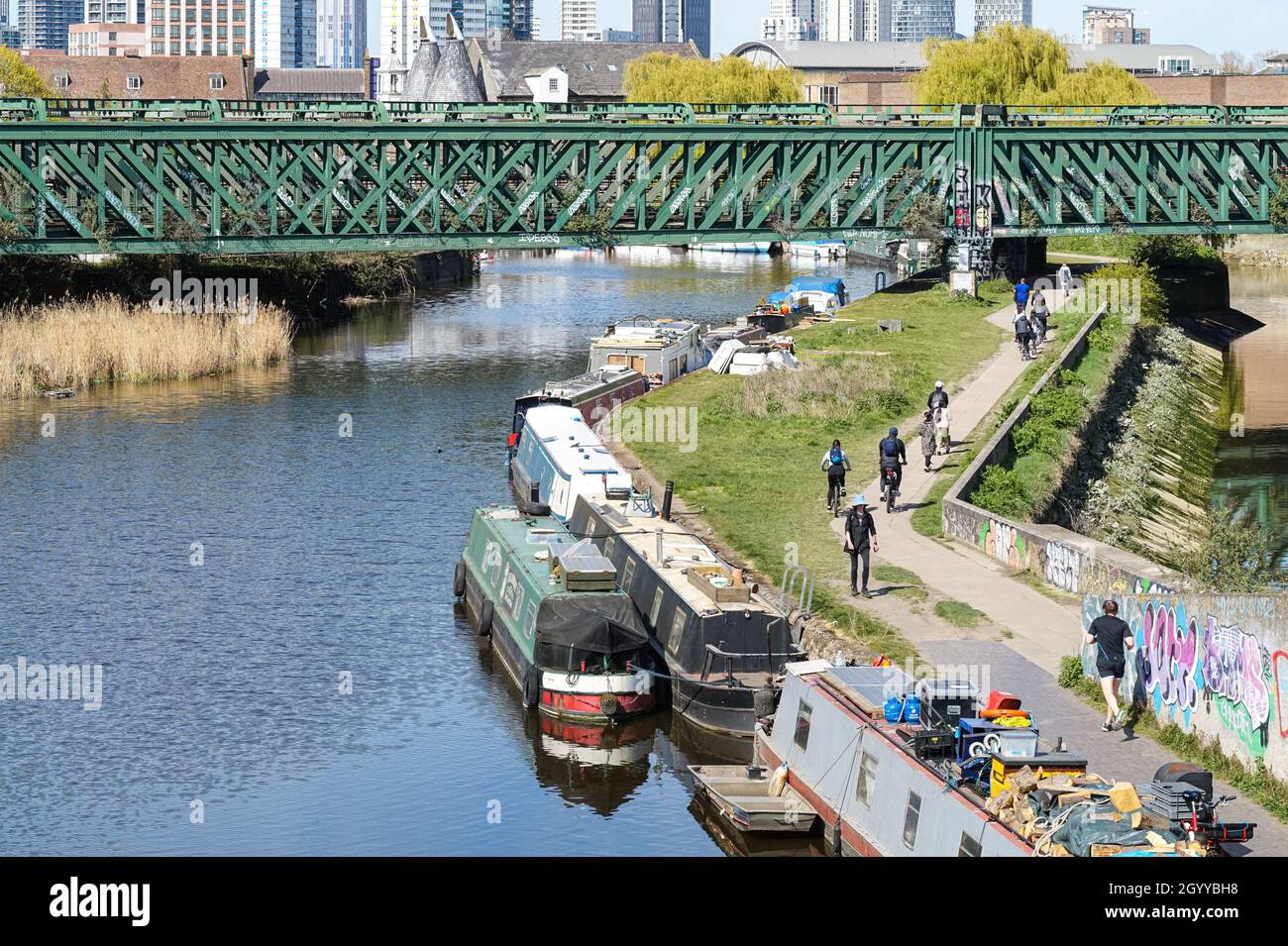 People enjoying sunny weather along the River Lea, London England ...