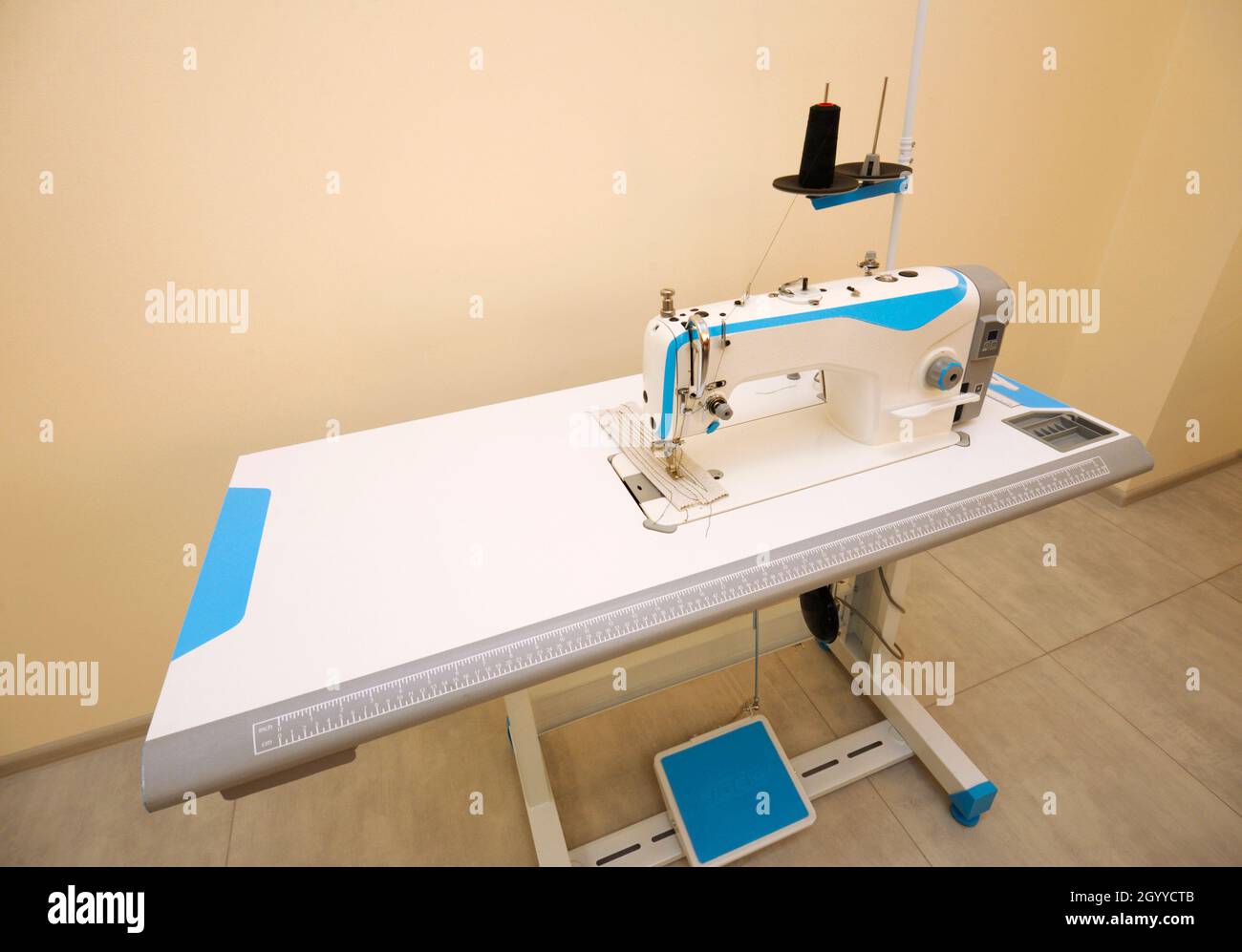 At the workshop. Electric sewing machine placed on a work table Stock ...