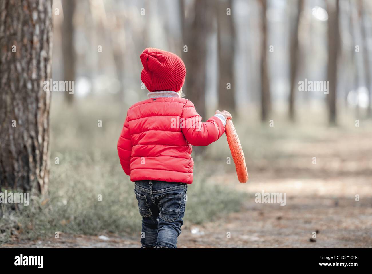 Little girl walking in the forest Stock Photo - Alamy