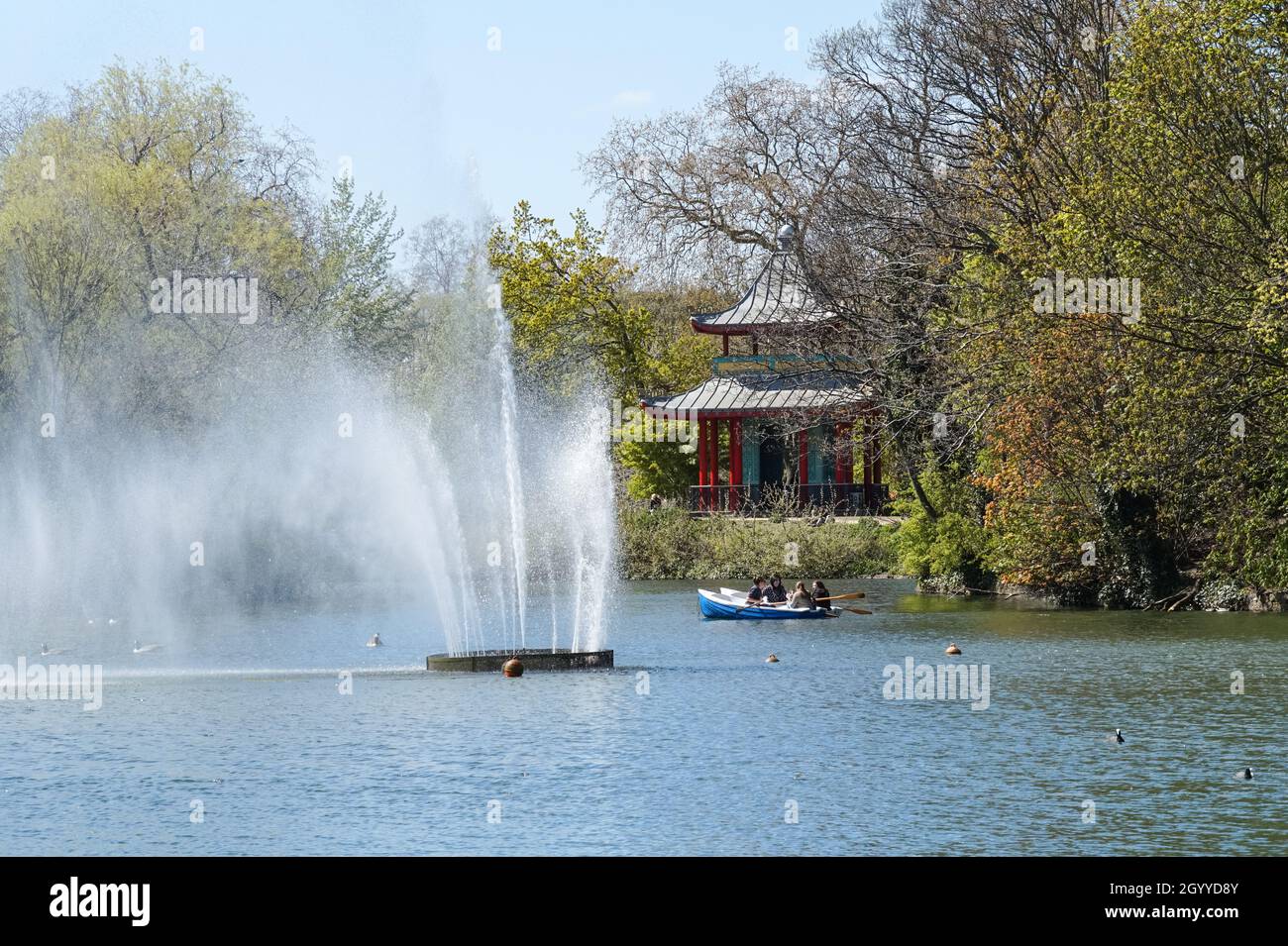 People enjoying sunny spring day in Victoria Park, London England ...