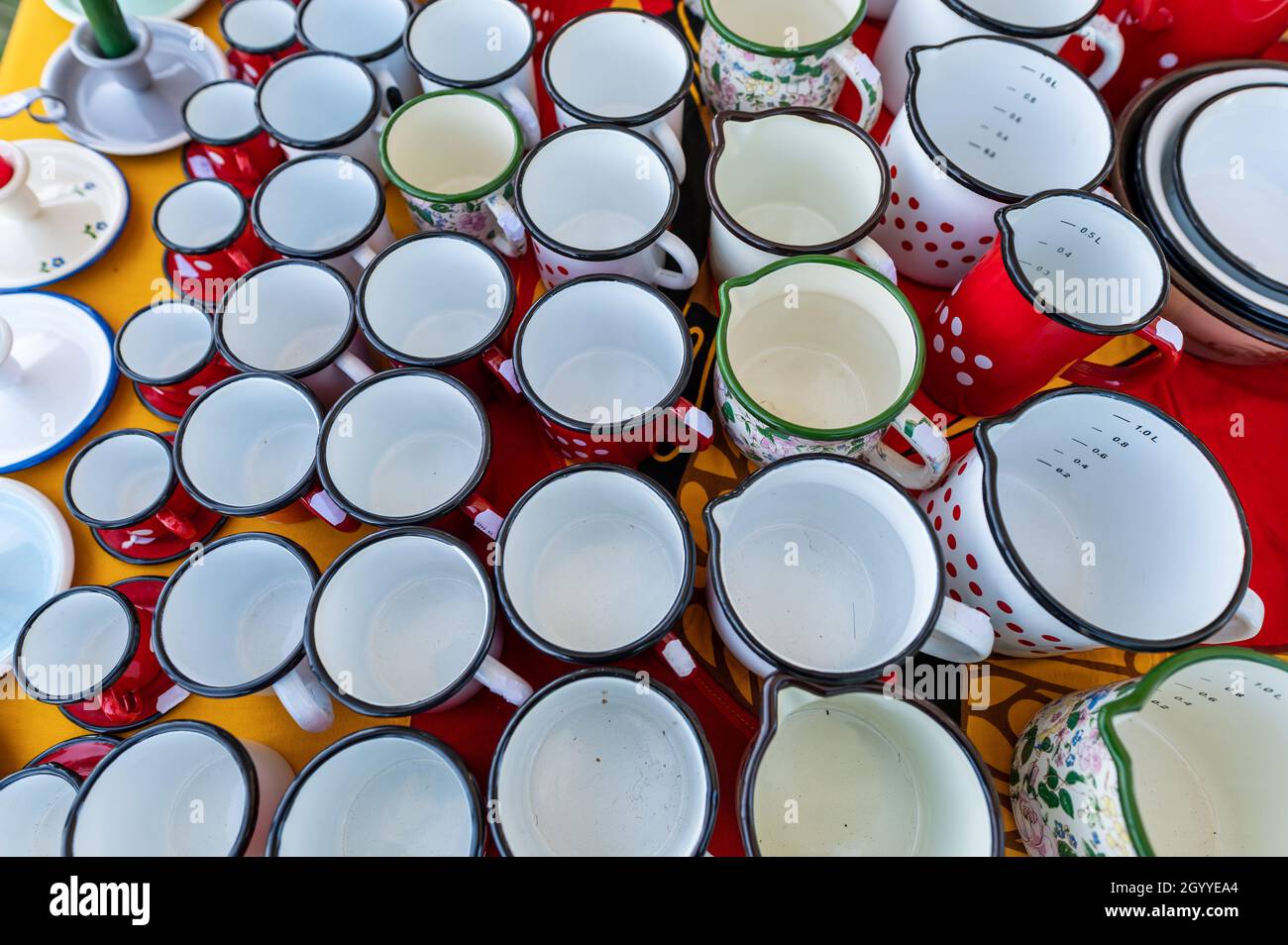 Milk pots of different sizes stand close together Stock Photo - Alamy