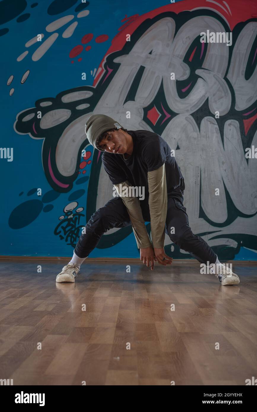 Modern rapper dancing in garage. Urban lifestyle, hip hop Stock Photo ...