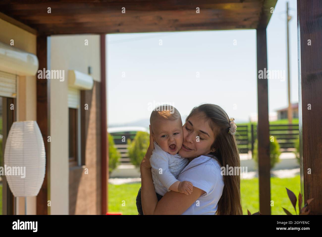 Beautiful and sweet mother is huggning her baby girl so much out of ...