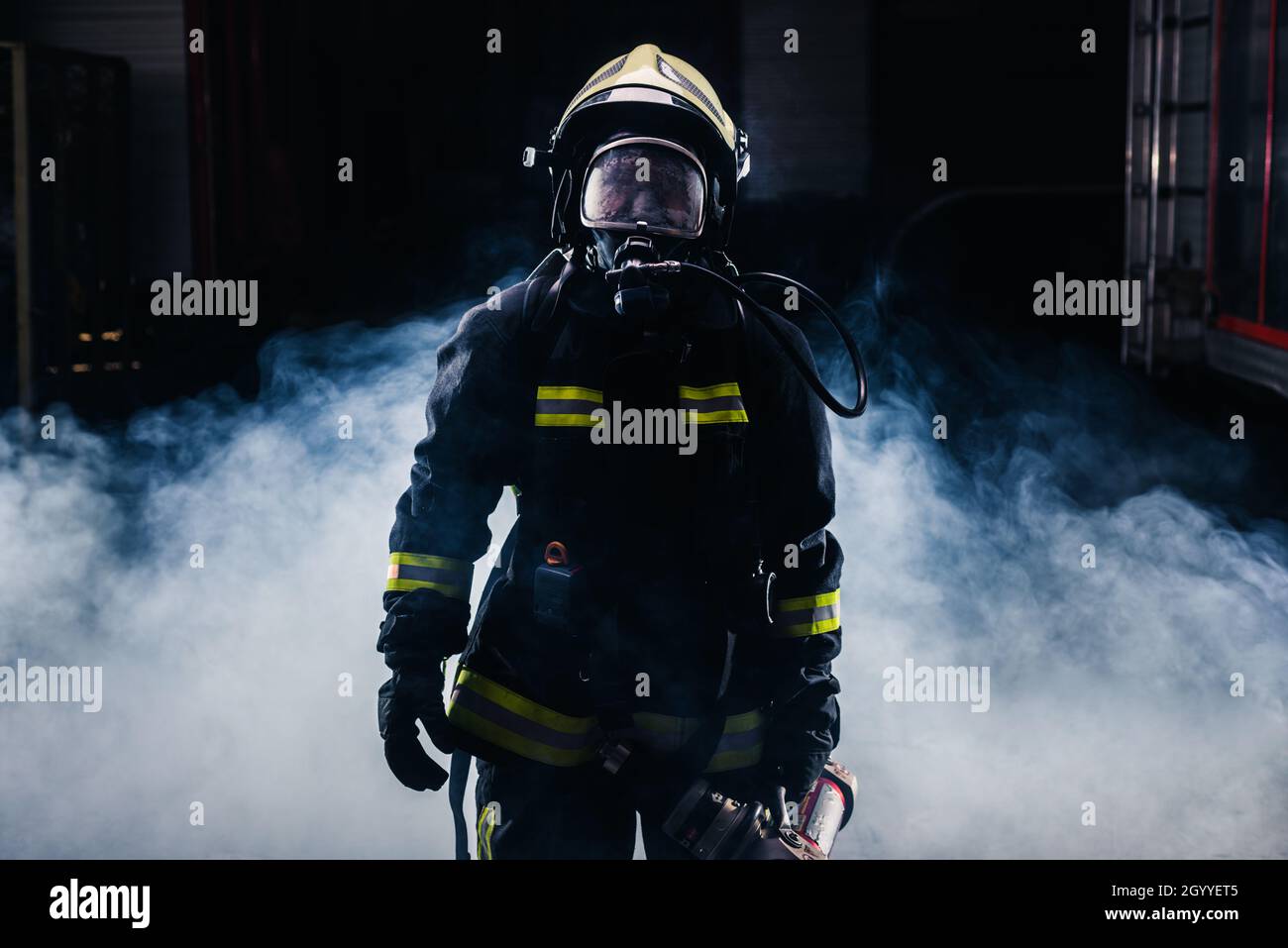 Portrait of a female firefighter wearing a helmet and all safety ...
