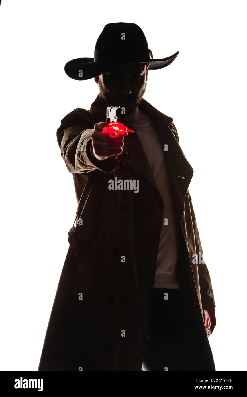 Good looking young man dressed in stylish sheriff outfit pointing a ...