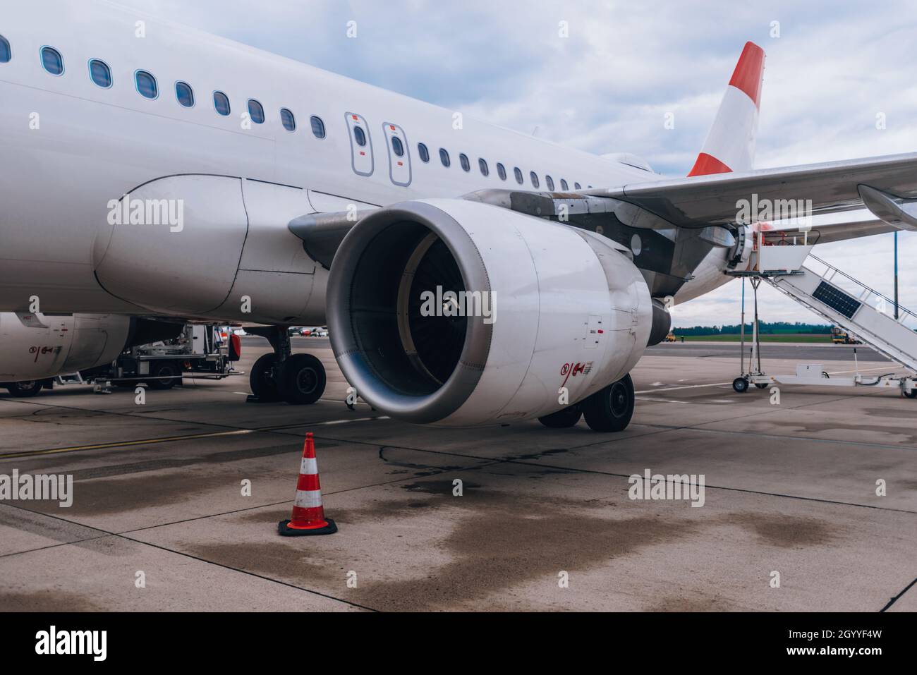 Airplane with jet engines and passenger boarding stairs at an aerodrome ...