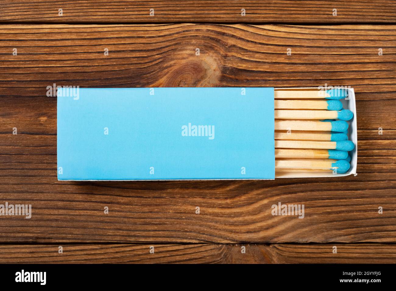 top view blue color matchbox with blue match sticks on a wood table ...