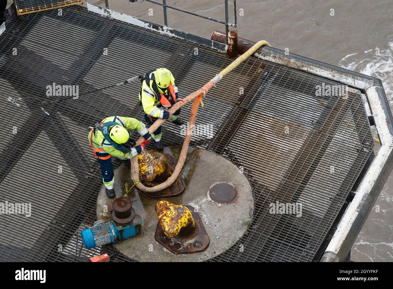Workers release the mooring rope of MS Stena Embla at Birkenhead docks ...