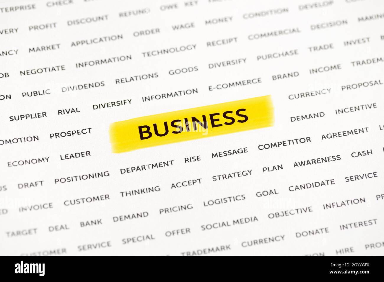The word "Business" is highlighted with a marker on paper. Business ...