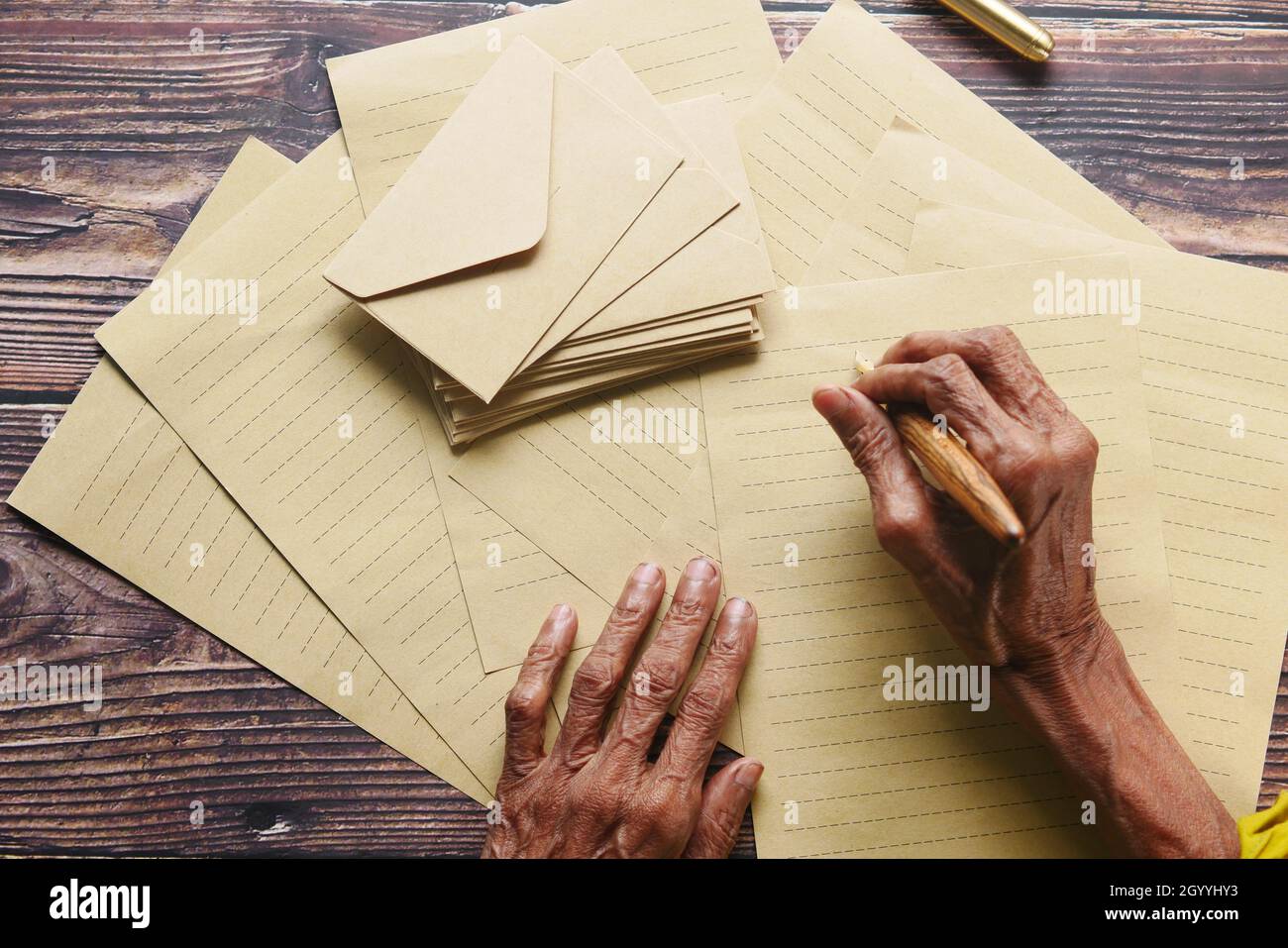 senior women hand writing on old paper with fountain pen Stock Photo ...