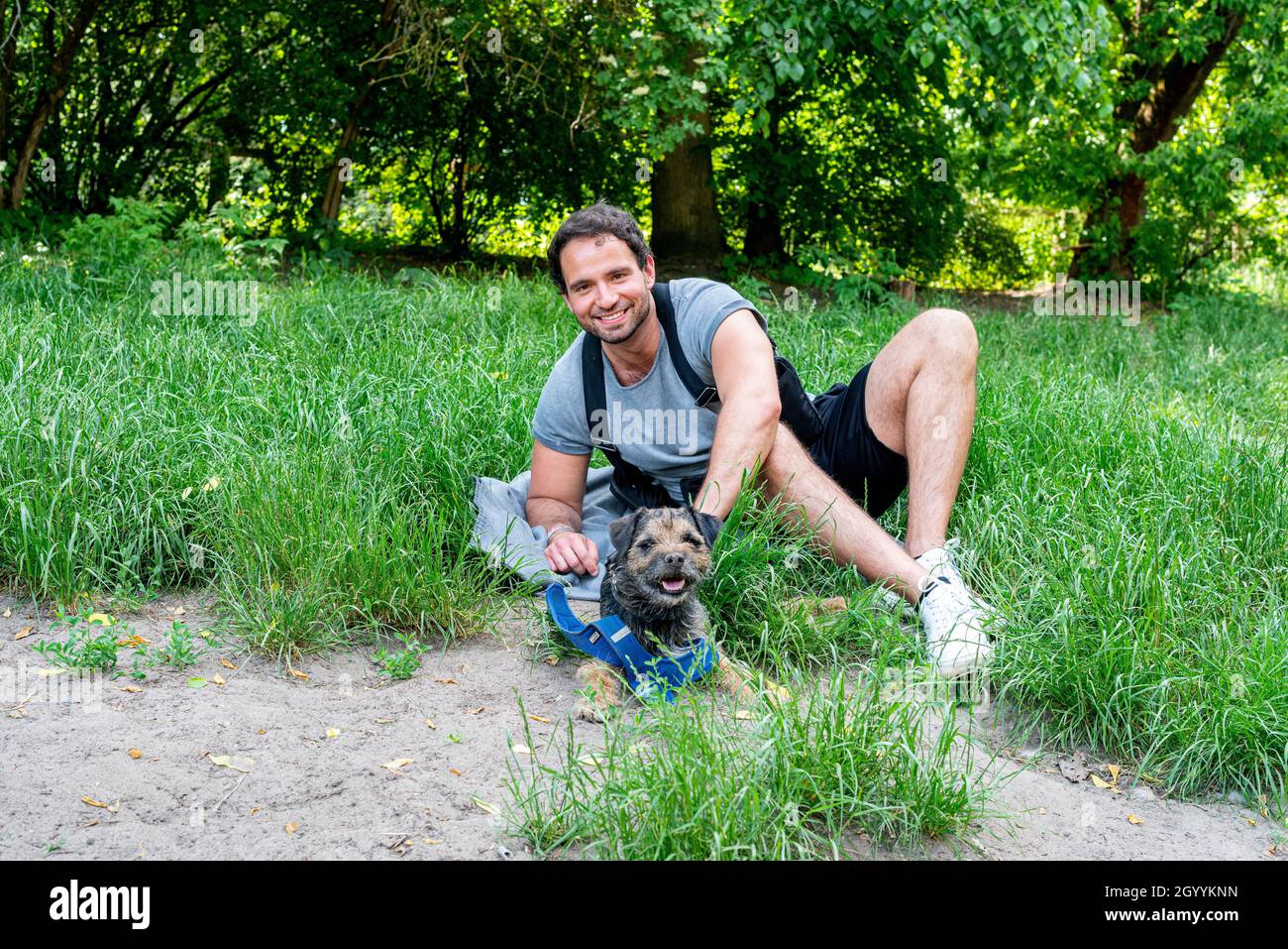 Berlin, Germany. Bastian playing with his new dog George inside the ...