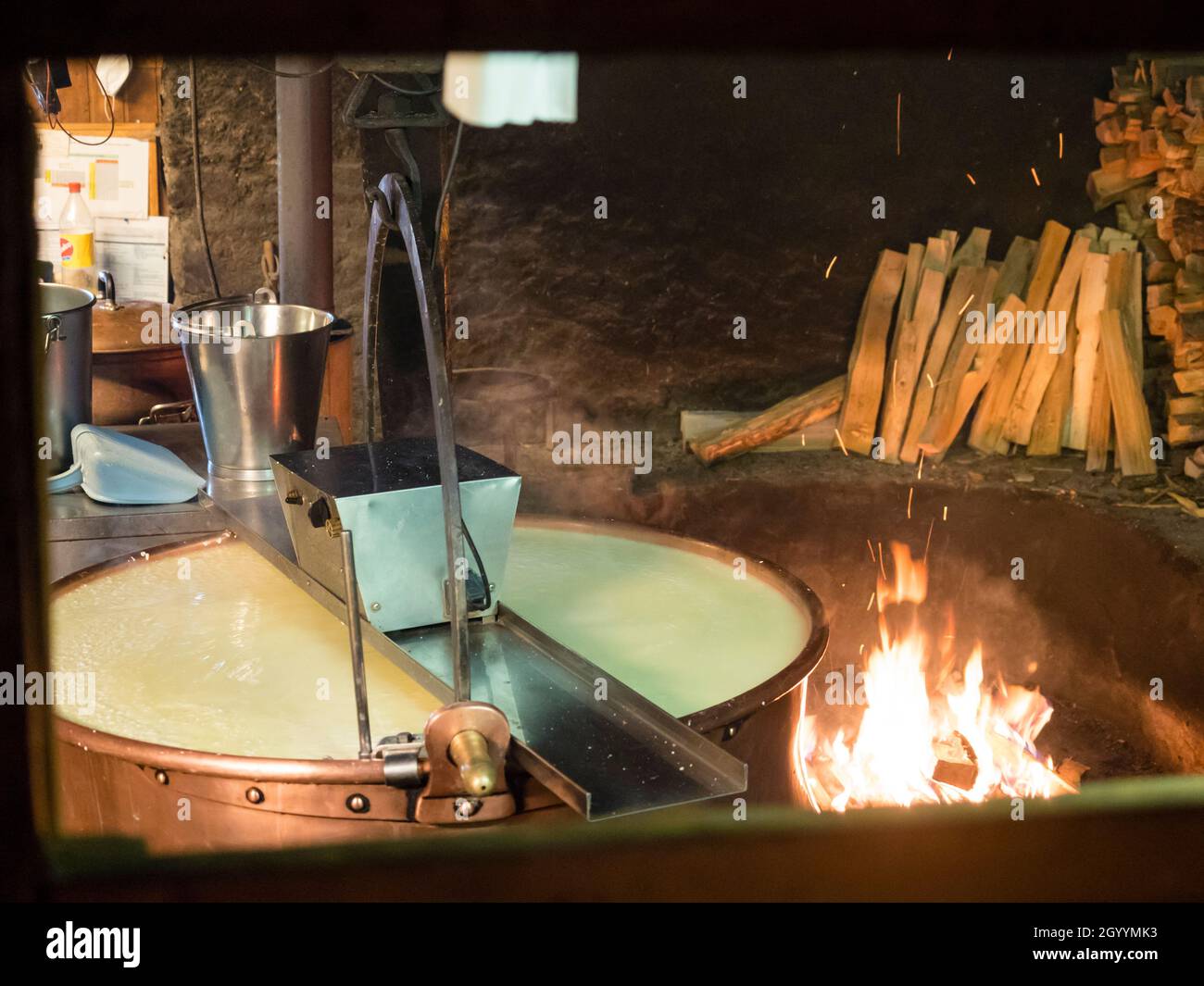 Traditional production of handmade Swiss Gruyere cheese at the alpine ...