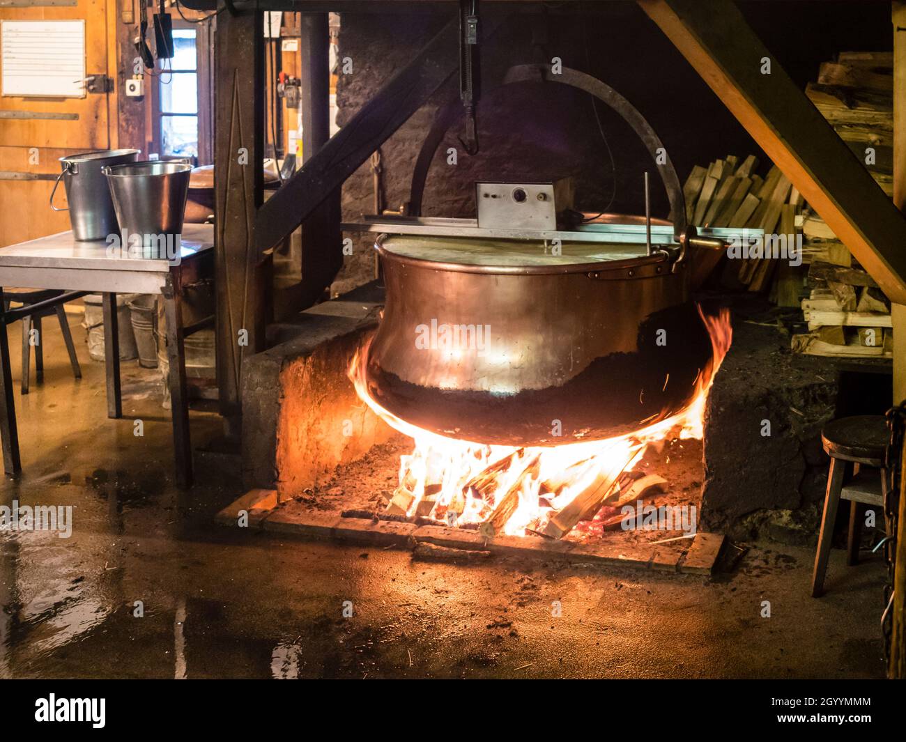 Traditional production of handmade Swiss Gruyere cheese at the alpine ...