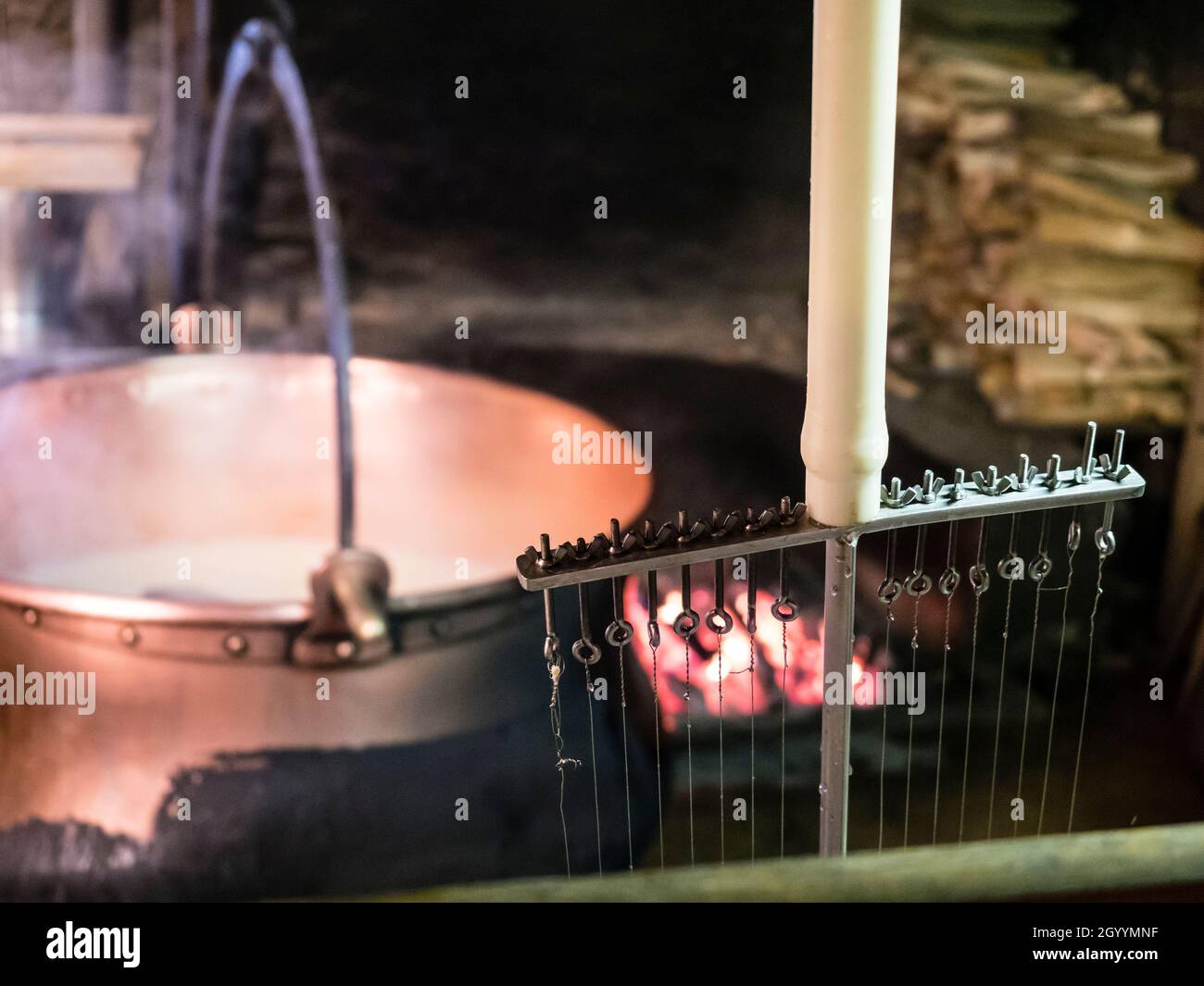 Production of cheese with cheese harp hi-res stock photography and ...