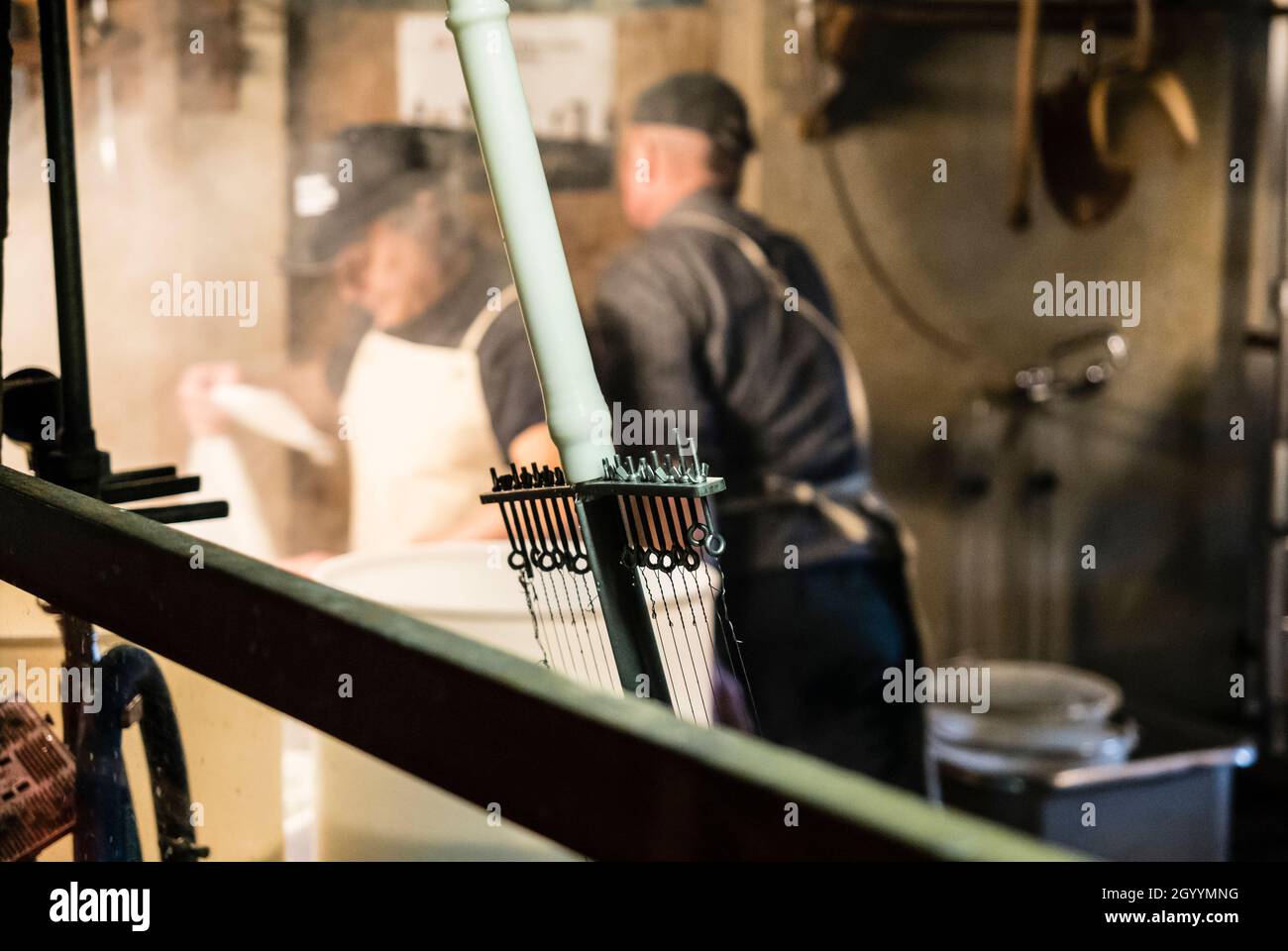 Traditional production of handmade Swiss Gruyere cheese at the alpine ...