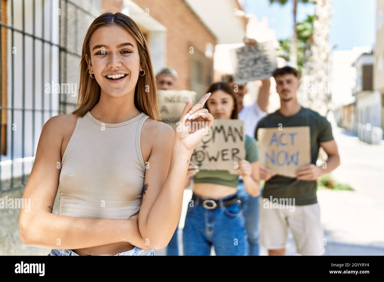 Group of people protesting and giving slogans at the street smiling ...