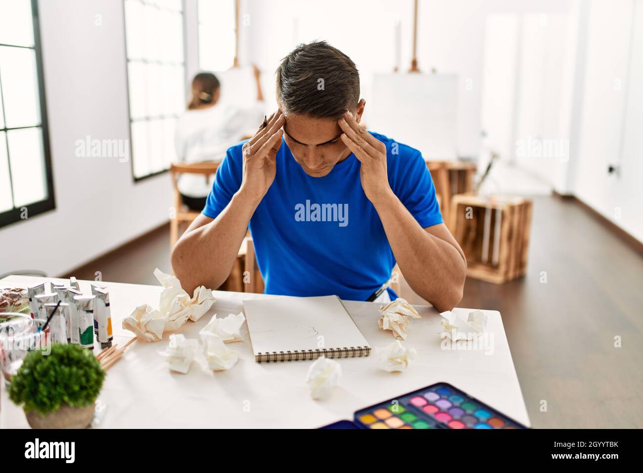 Paint student man stressed painting at art school Stock Photo - Alamy
