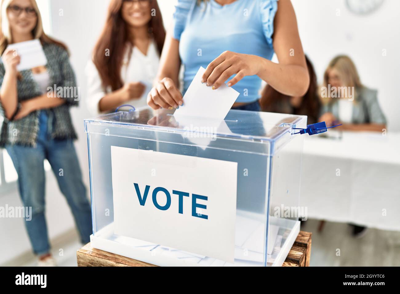 Group of young voter woman smiling happy putting vote in voting box at ...