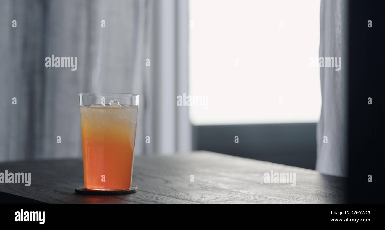 lemonade with crushed ice in tumbler glass on oak table, wide photo ...