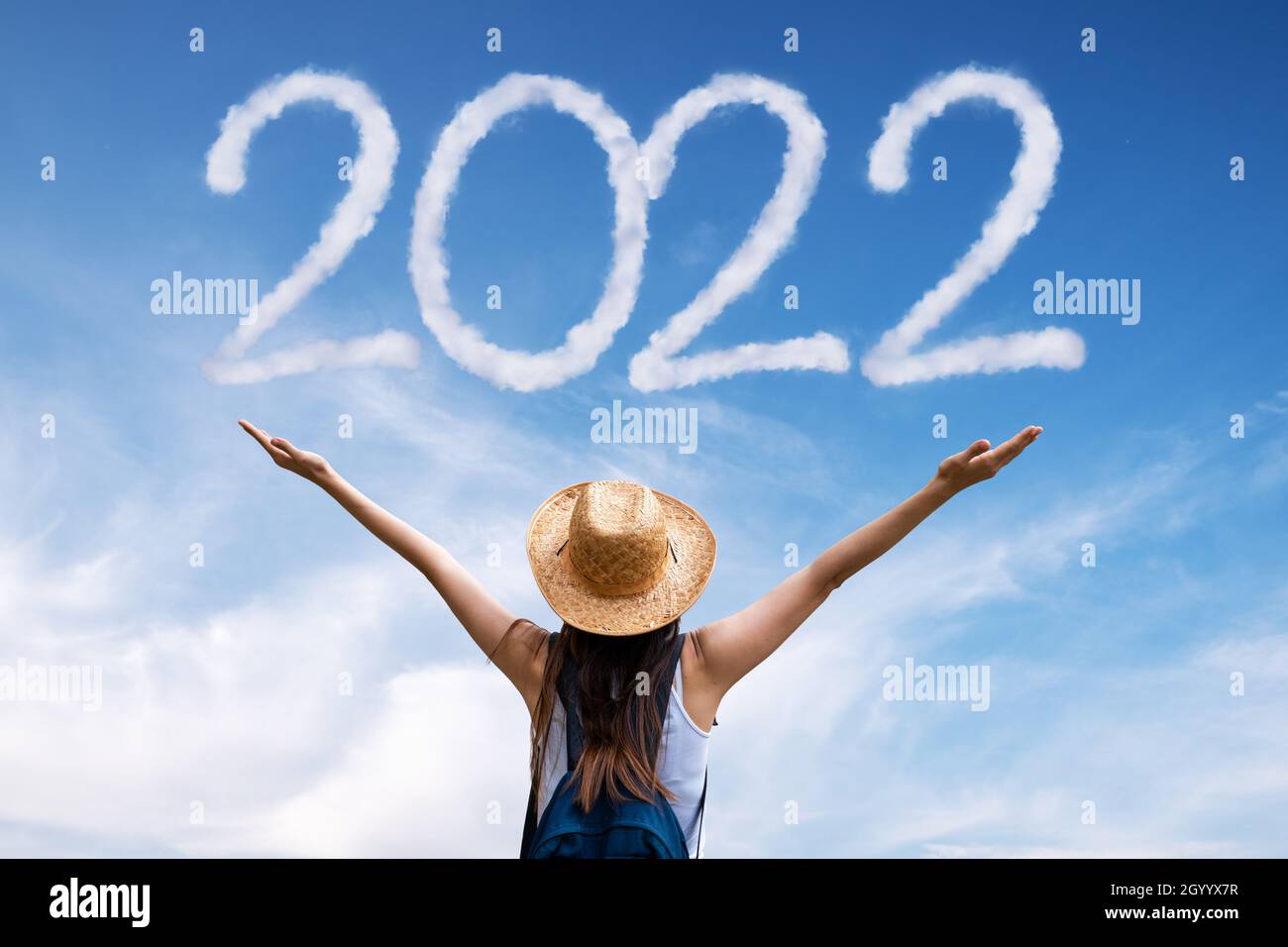 Beautiful woman greets the 2020 portrayaled with clouds Stock Photo - Alamy