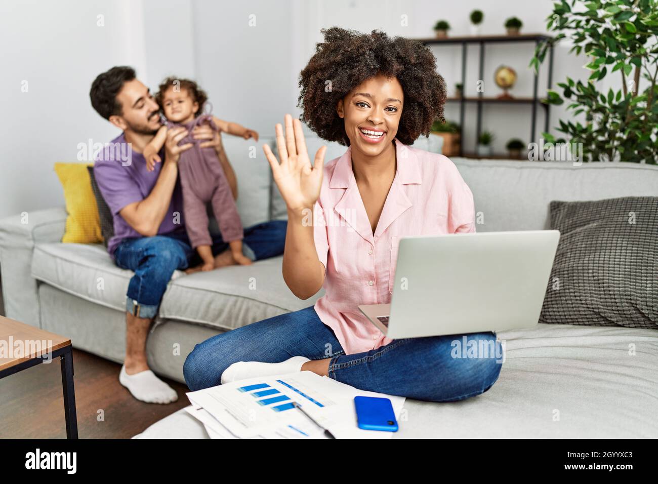 Mother of interracial family working using computer laptop at home ...