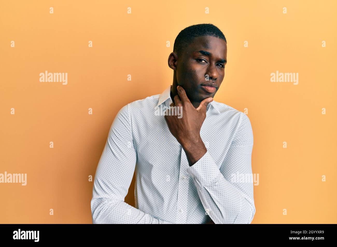 Young african american man wearing casual clothes thinking concentrated ...