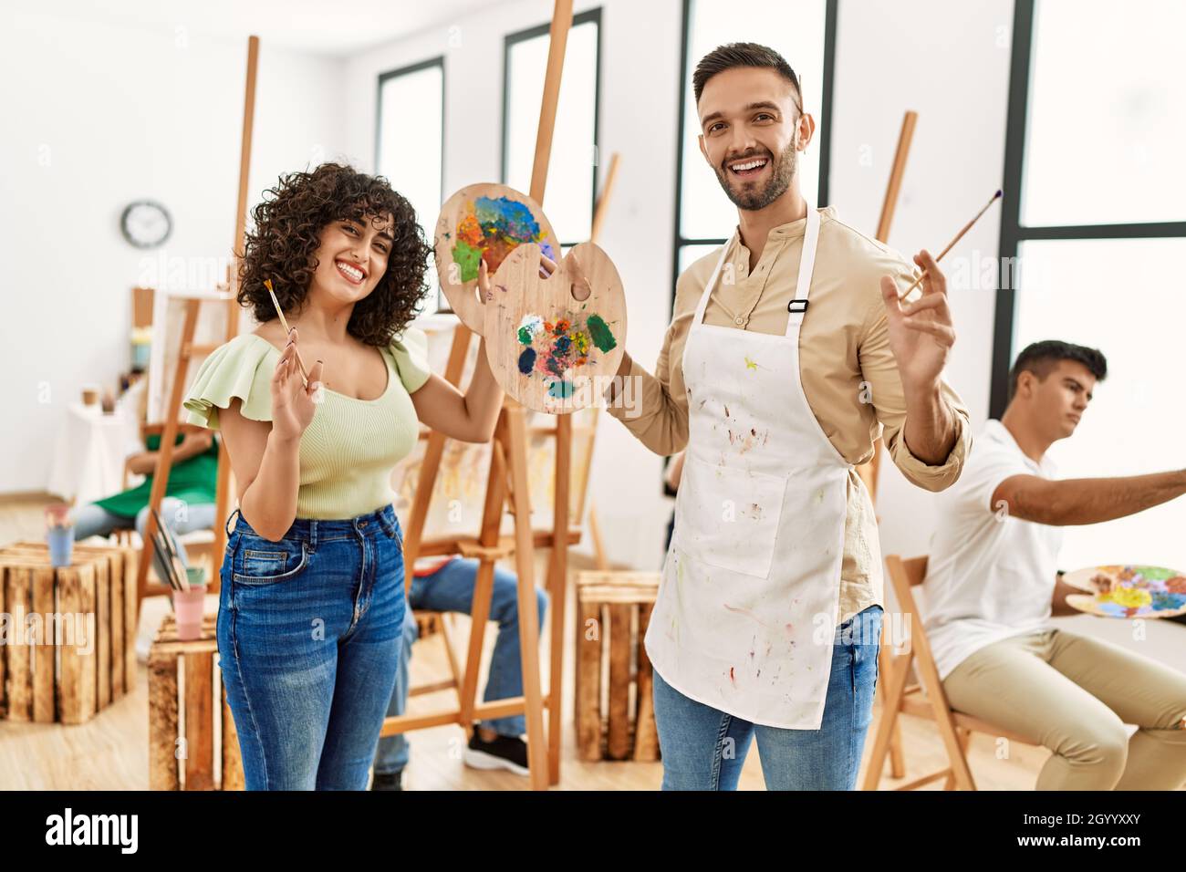 Group of people drawing at art studio. Man and woman smiling happy ...