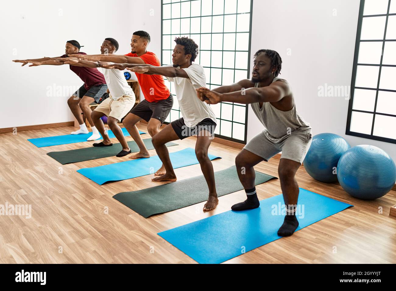 Group of young african american man training yoga at sport center Stock ...