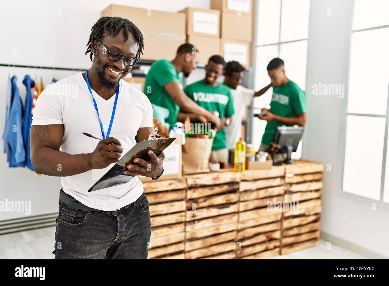 Group of young african american volunteers working at charity center ...