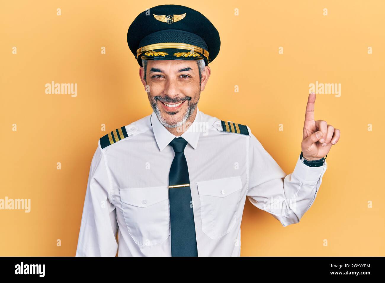 Handsome middle age man with grey hair wearing airplane pilot uniform ...