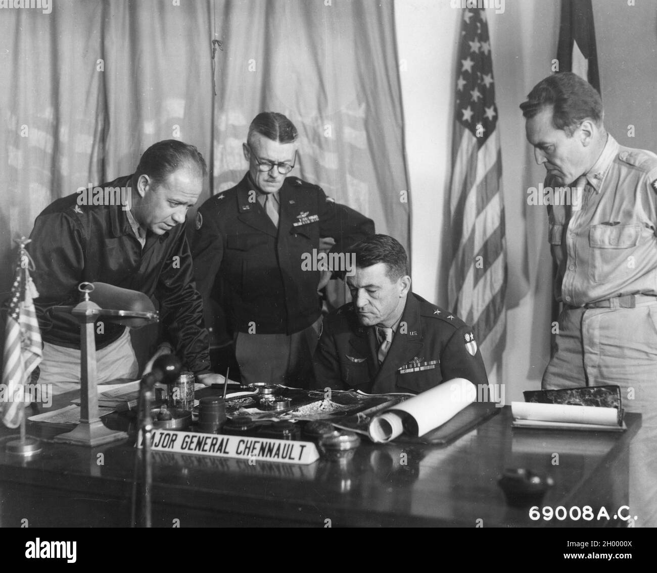 Major Gen. Claire Chennault of the US Air Force (seated) studies aerial ...