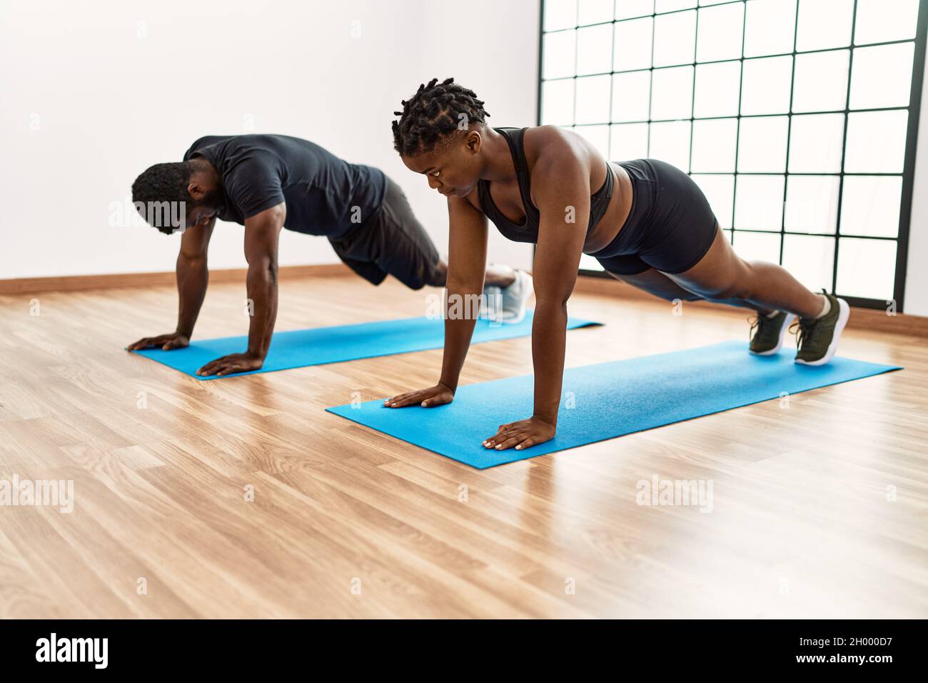 Young african american sporty couple doing core abs exercise at sport ...