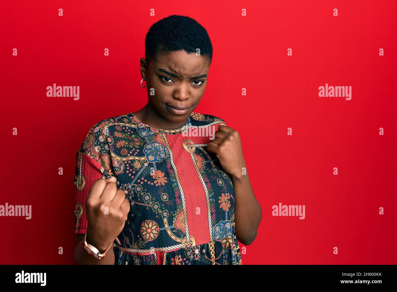 Young african american woman wearing african style angry and mad ...